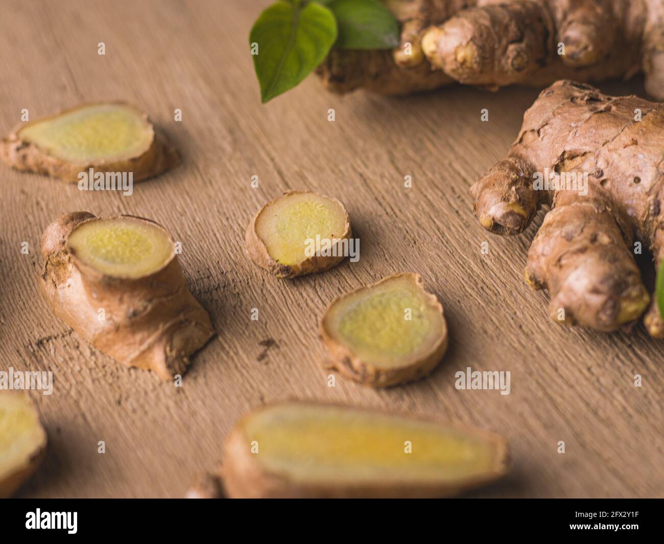 Fresh Ginger on wooden texture background stock image Stock Photo - Alamy