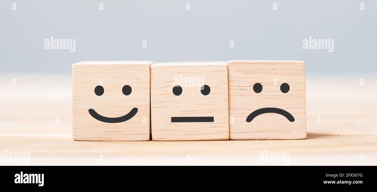 emotion face symbol on wooden cube blocks. Service rating, ranking ...