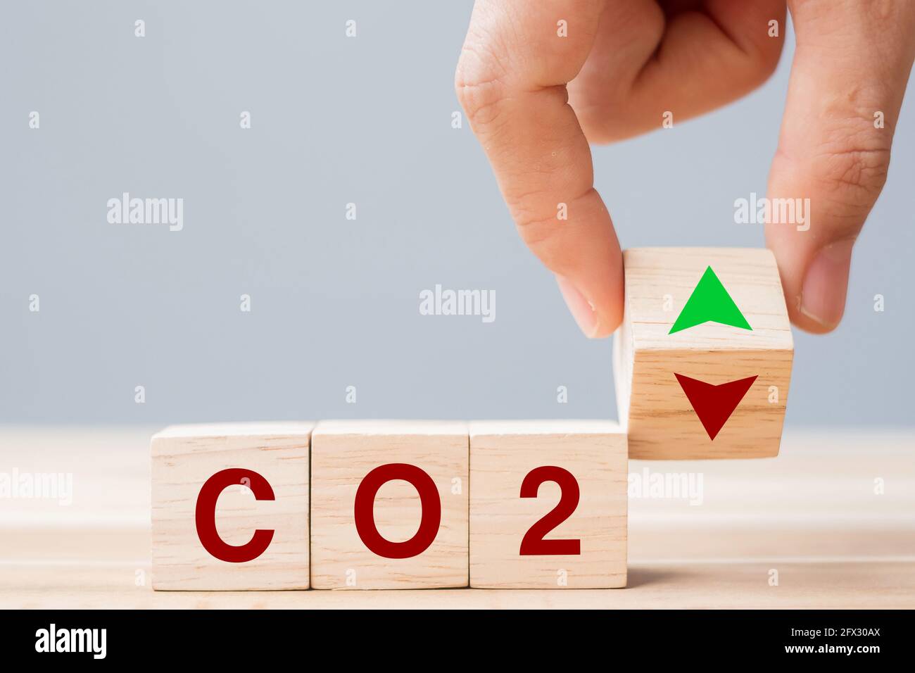 hand flipping wooden cube blocks to UP and Down arrow symbol with CO2 ...