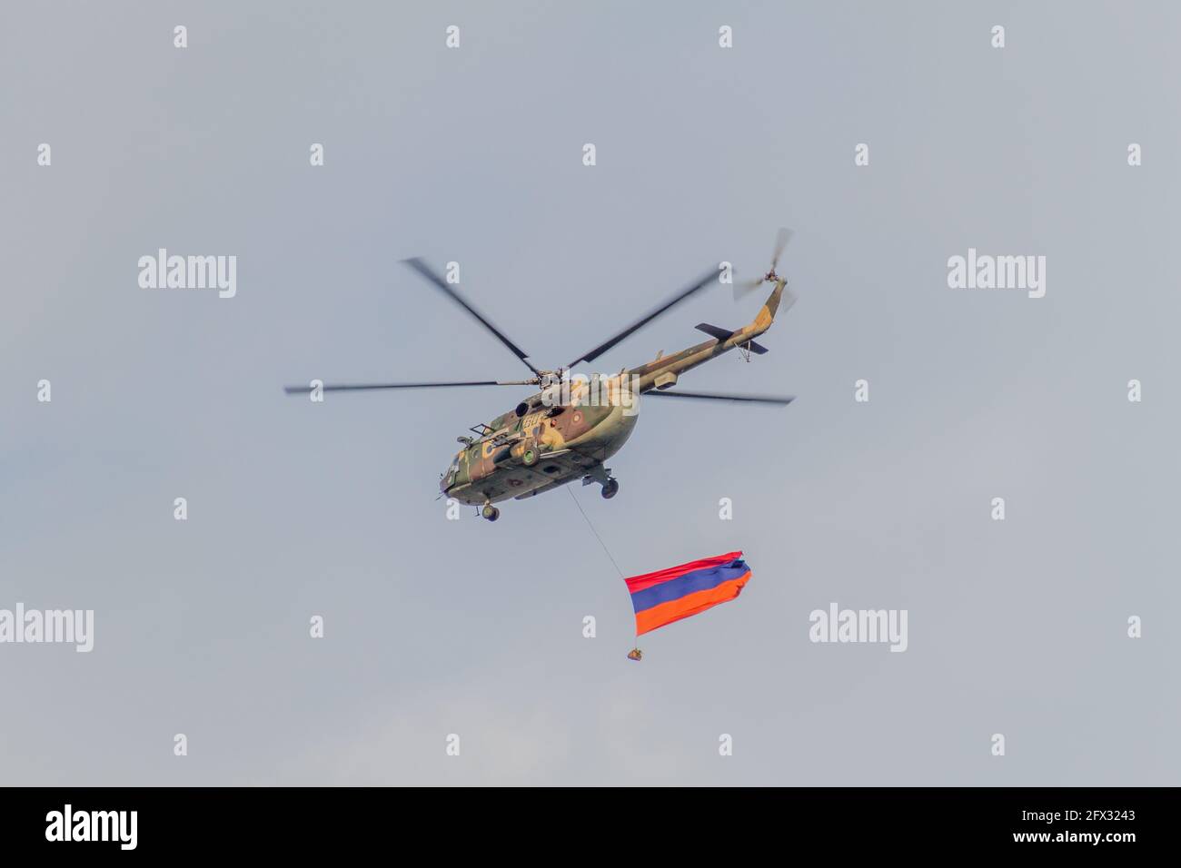 YEREVAN, ARMENIA - JULY 5, 2017: Helicopter carrying the national flag ...