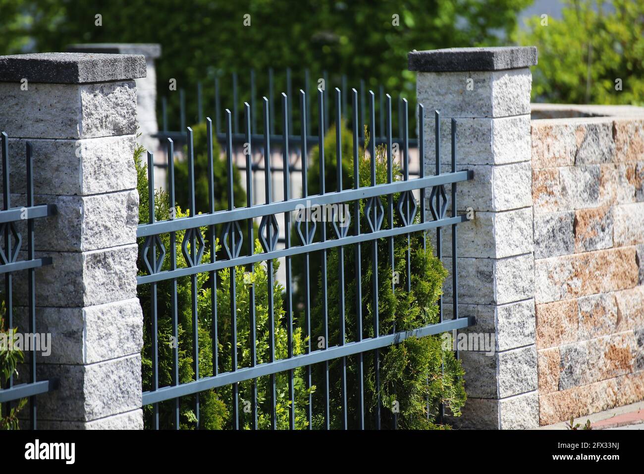 Beautiful and high-quality metal fence as property boundary or garden ...