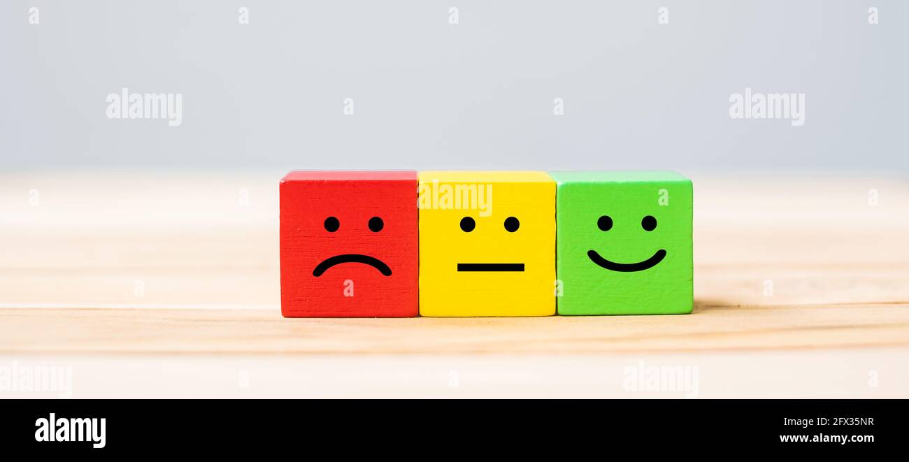 Emotion face symbol on wooden cube blocks. Service rating, ranking ...