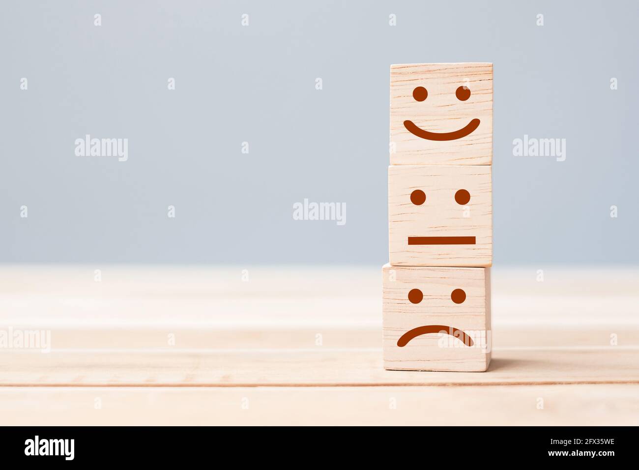 smile face symbol on yellow wooden cube blocks. Emotion, Service rating ...