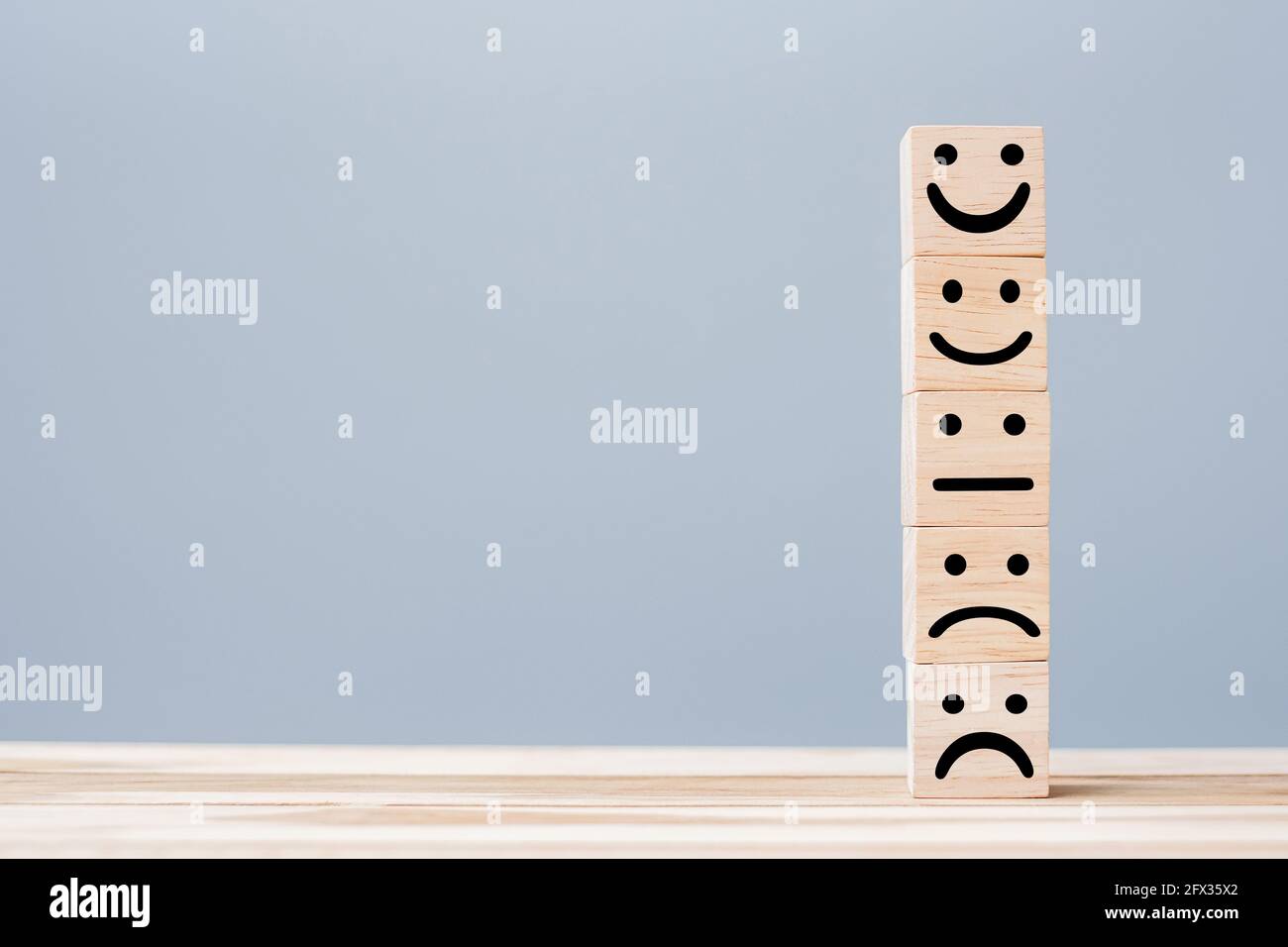 smile face symbol on yellow wooden cube blocks. Emotion, Service rating ...