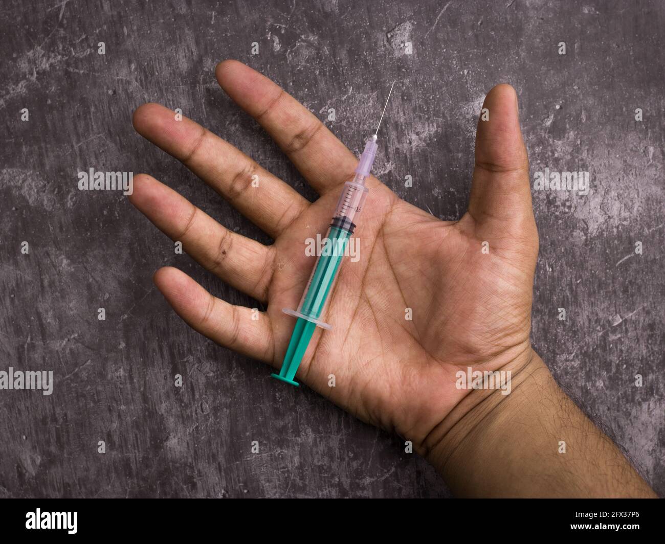 Side effects of steroid with syringe and human hand on textured ...