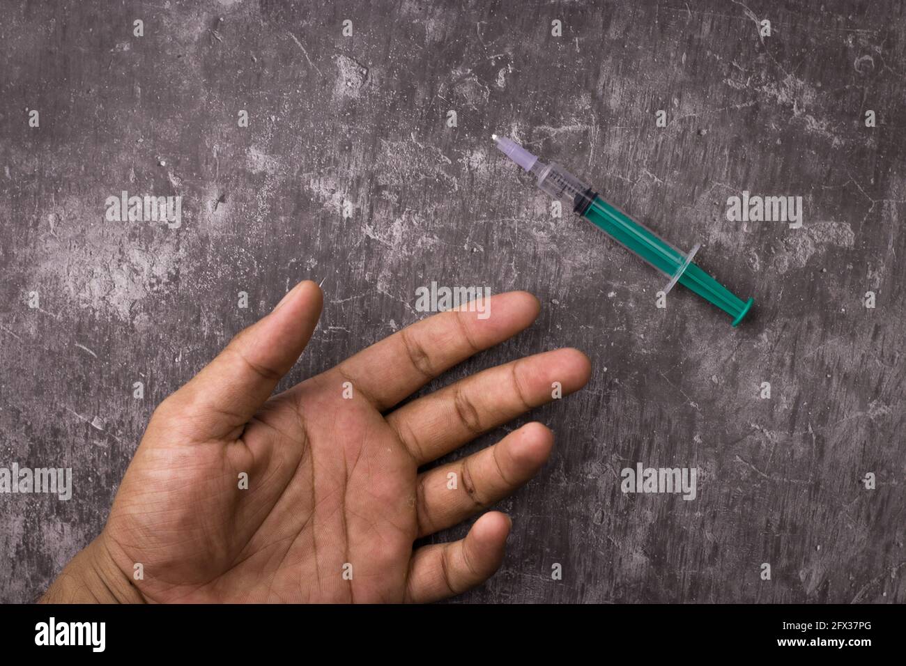 Side effects of steroid with syringe and human hand on textured ...