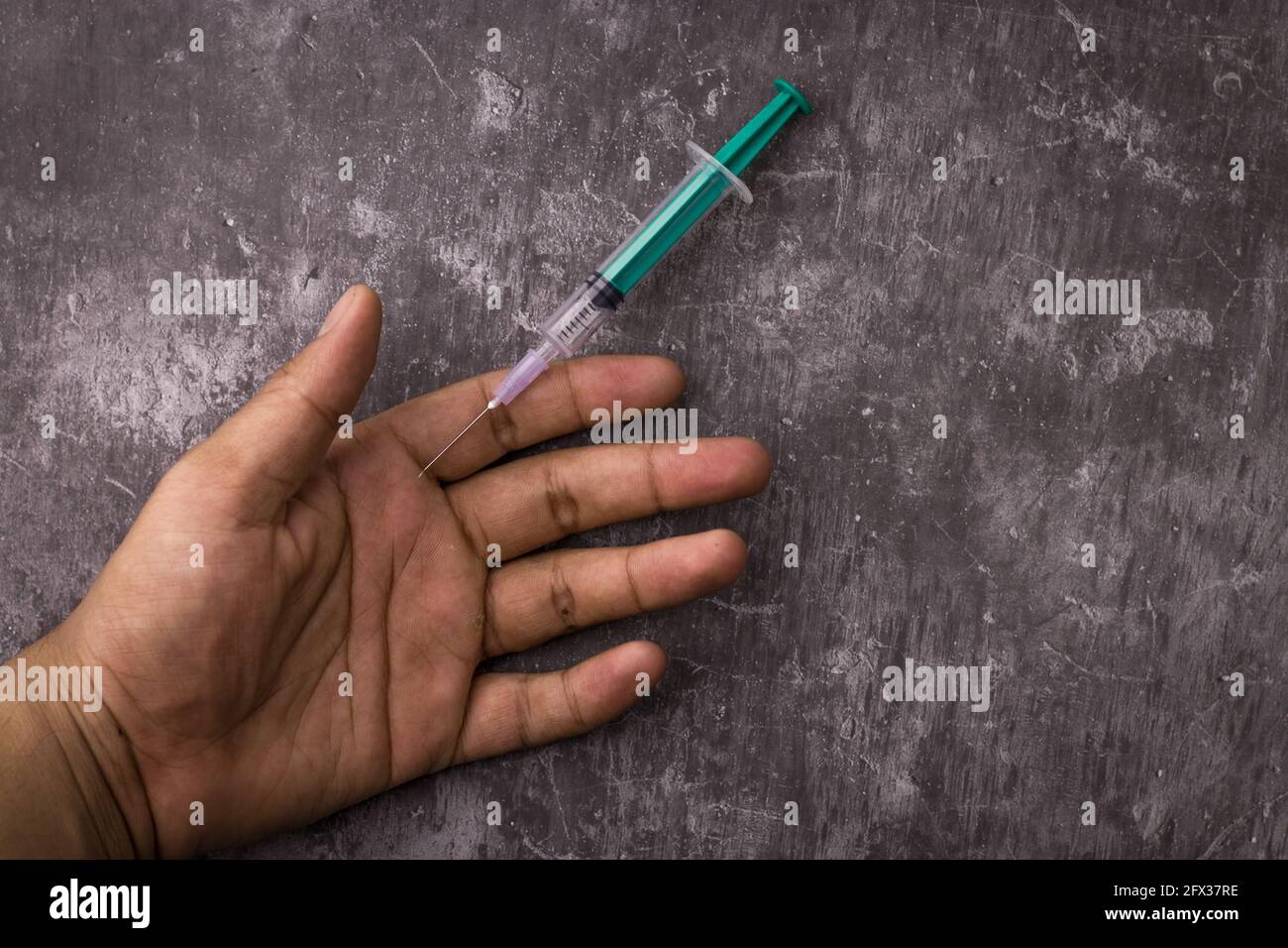 Side effects of steroid with syringe and human hand on textured ...