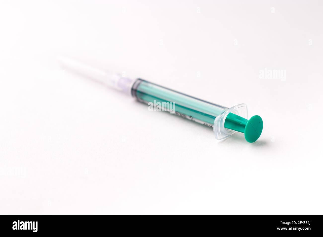 Plastic Syringe isolated stock image on texture background Stock Photo ...