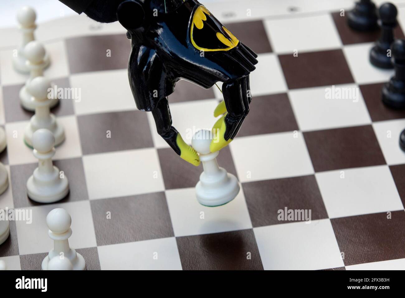 A person with a bionic prosthetic arm plays chess Stock Photo - Alamy