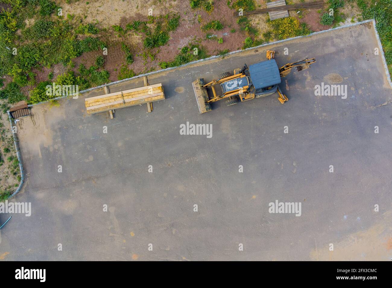 Aerial view of forklift stacker wooden boards on beams house on of new ...