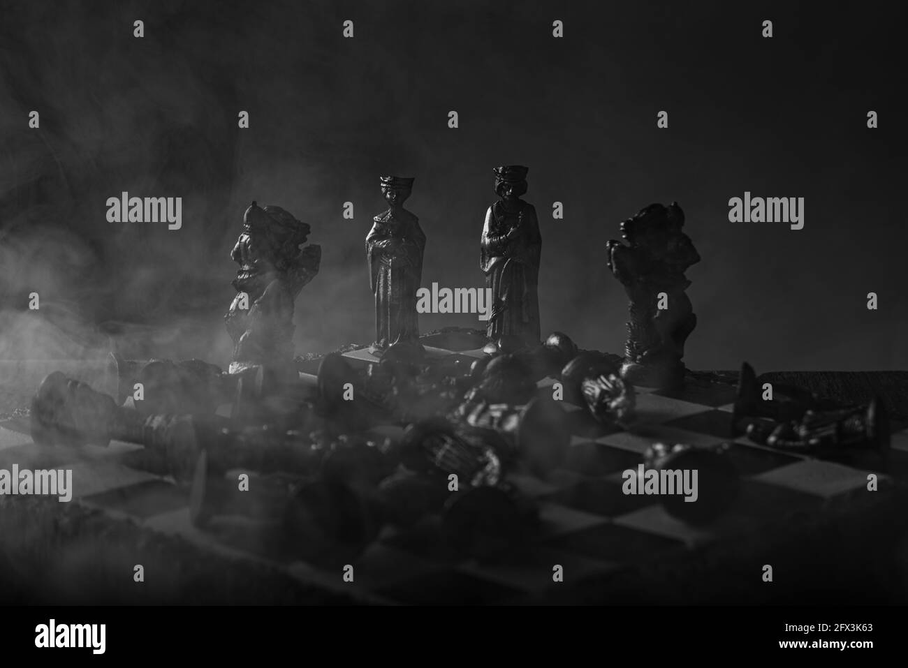 stylized chess pieces on a board with black background, smoke and ...