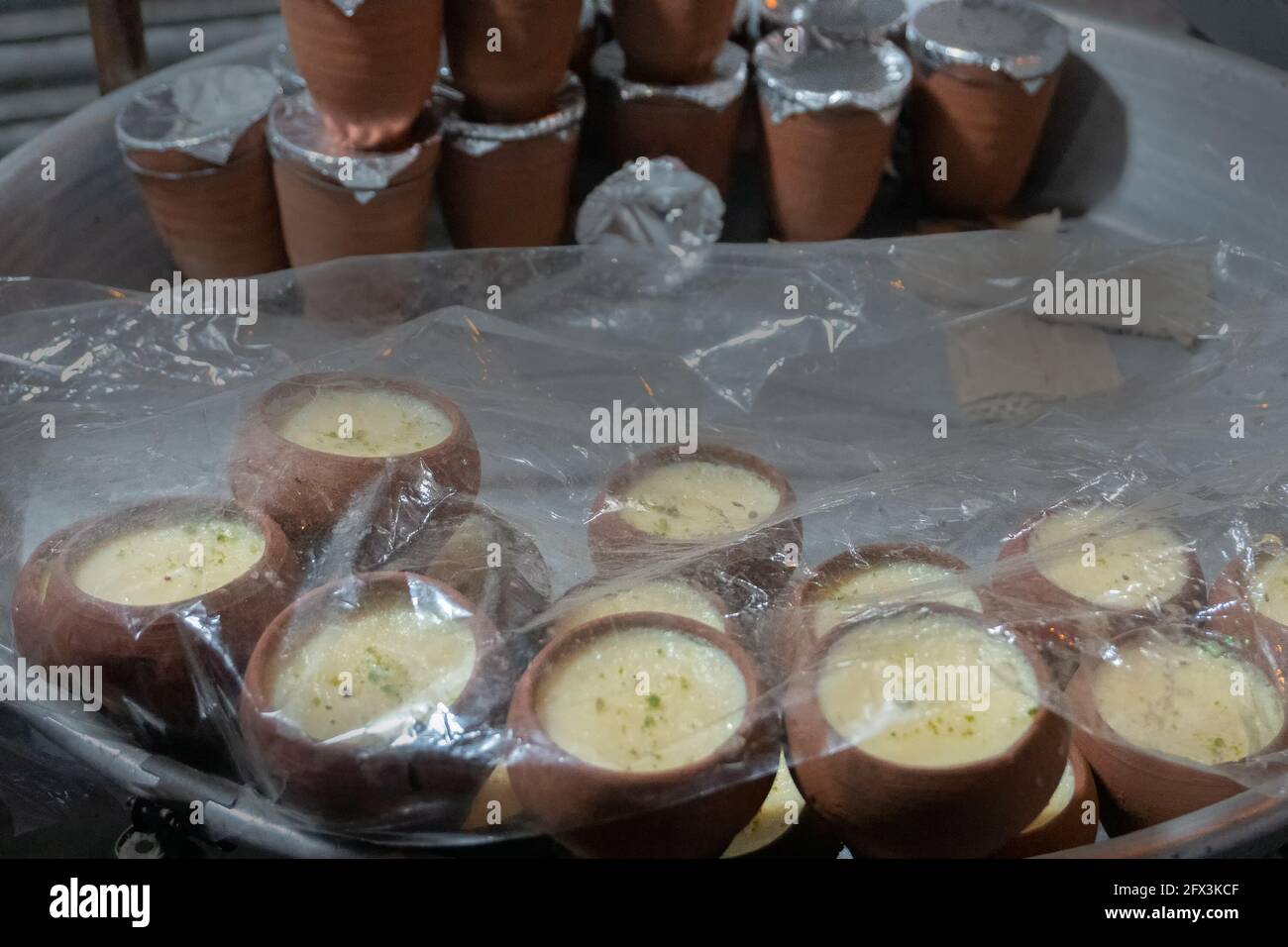 Rabri in clay containers for sale. Rabri is a sweet, condensed-milk ...