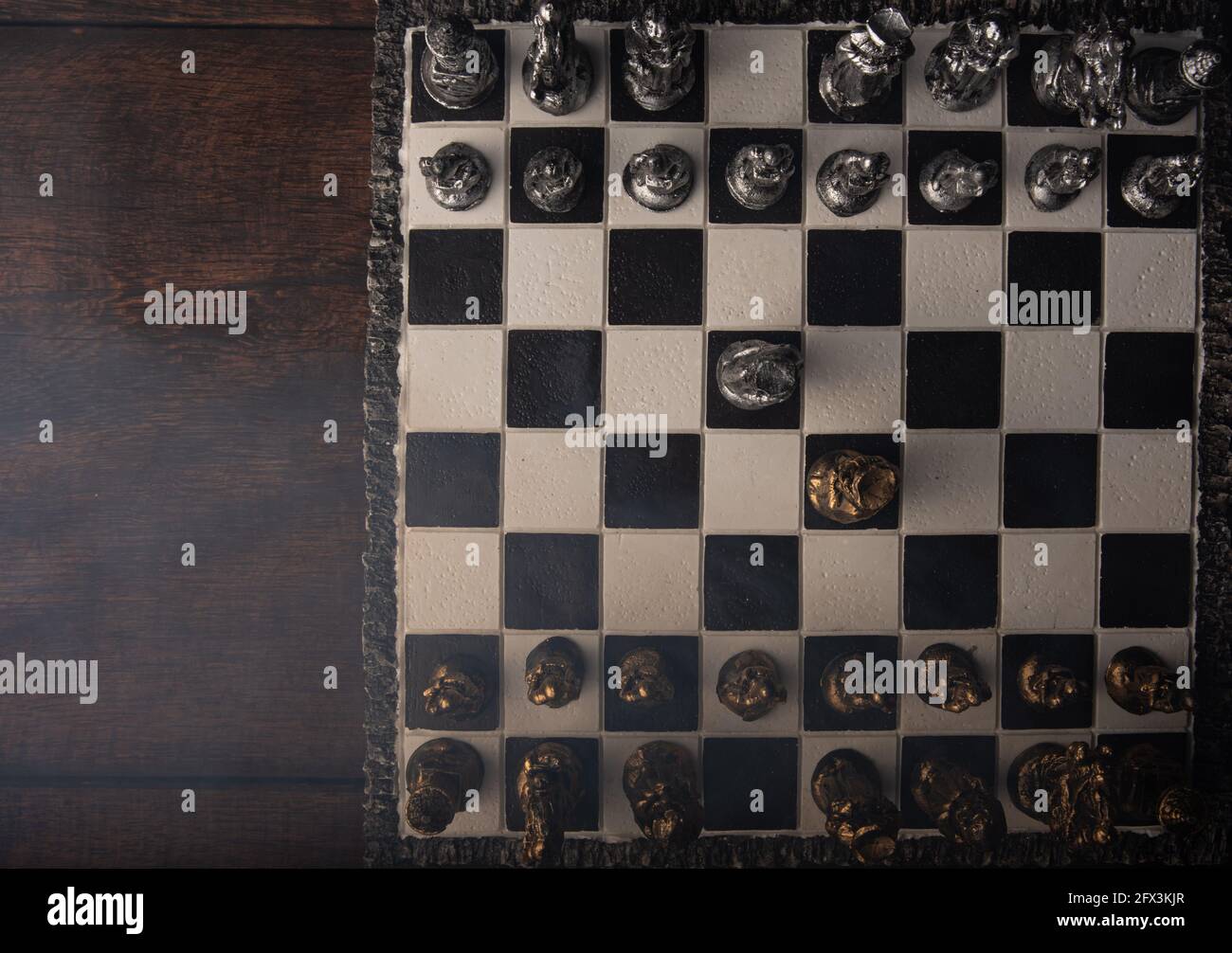 stylized chess pieces on a board with black background, smoke and top ...