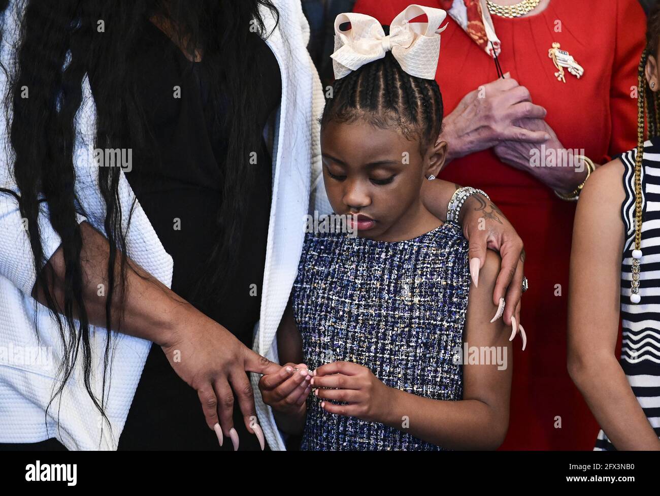 Gianna Floyd, George Floyd's daughter, holds the hand of her mother ...