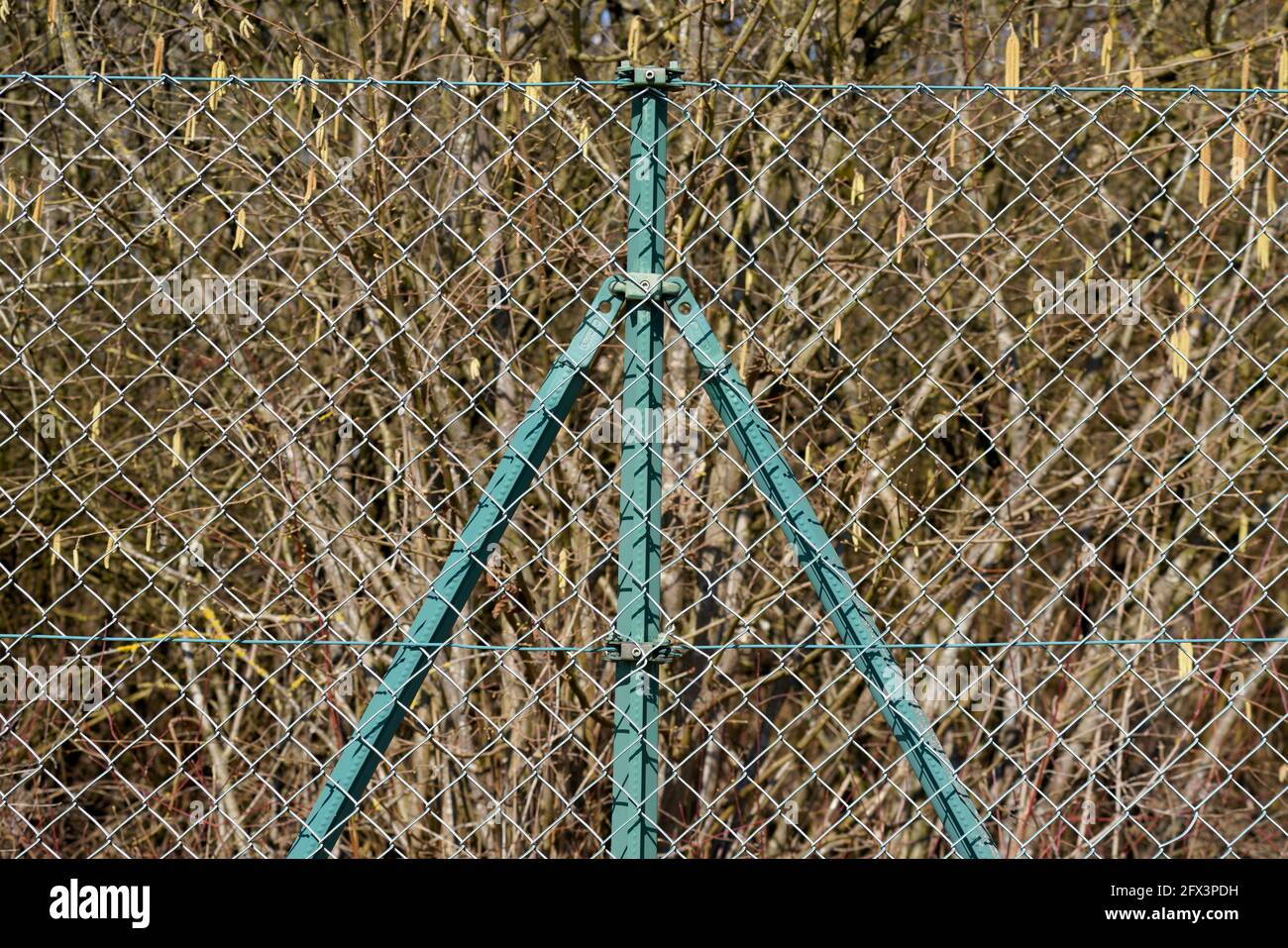 Wooden decorative fence, iron chain link fence Stock Photo - Alamy