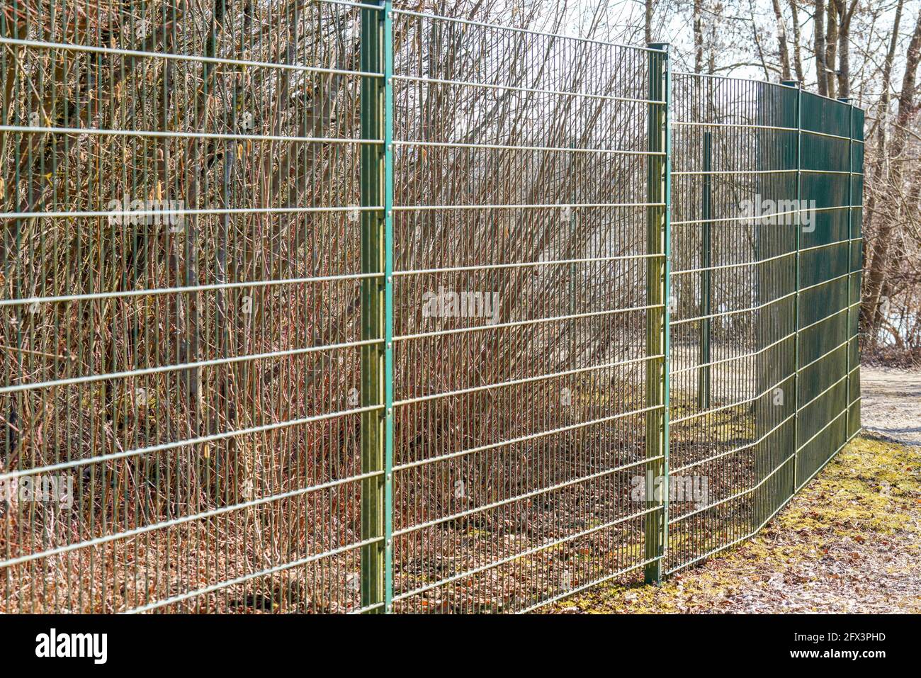 Wooden decorative fence, iron chain link fence Stock Photo - Alamy