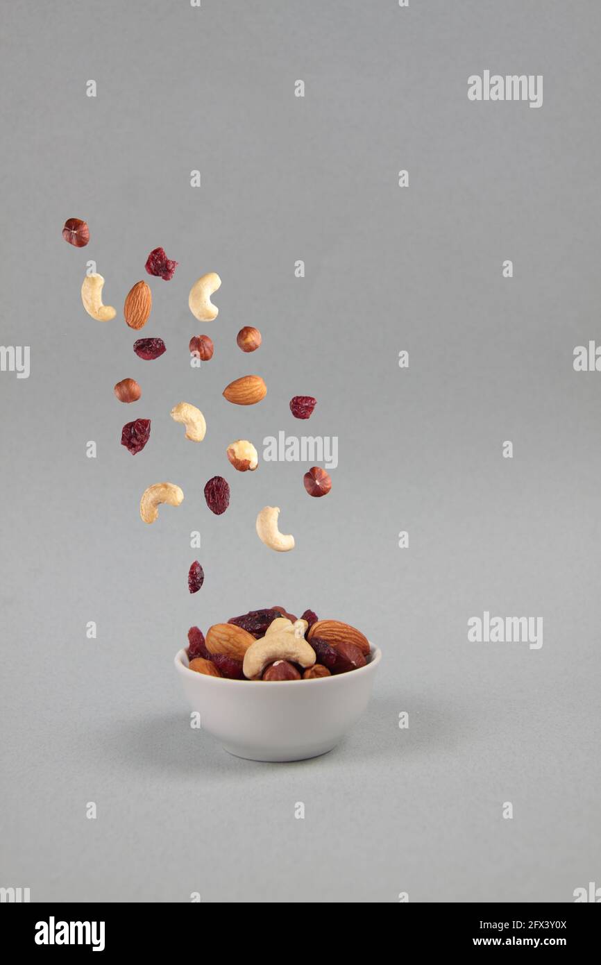 fruit mix pouring into a bowl isolated on gray background - flying food ...
