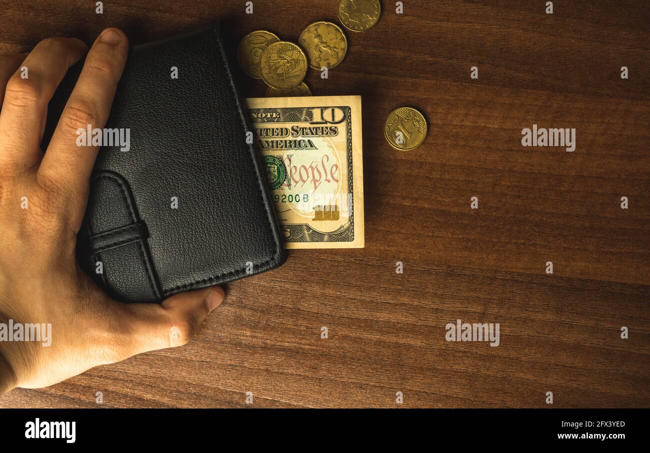Man hold wallet with last savings money, ten dollar with cents in men's ...