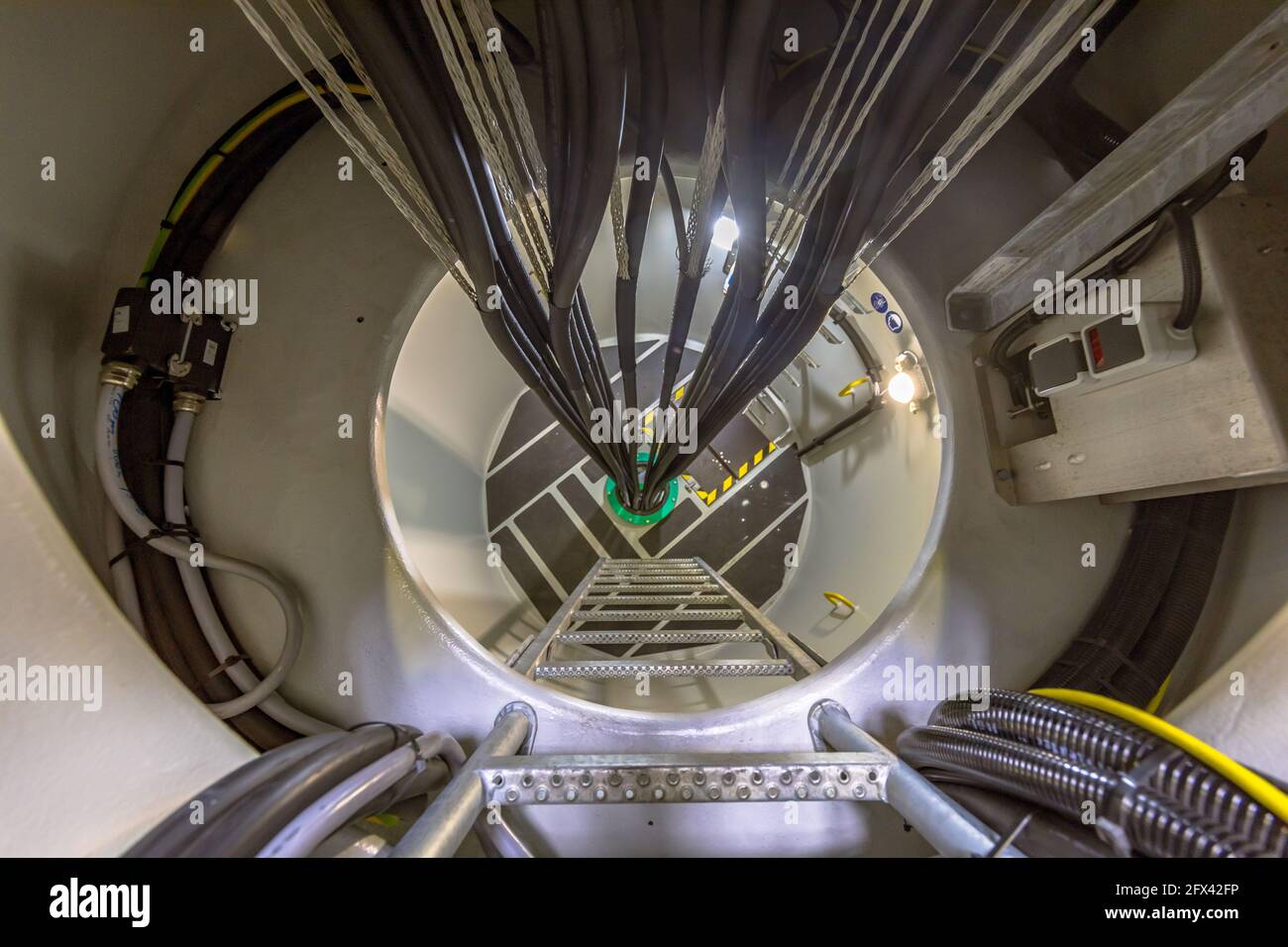 Interior of a modern wind turbine mast. A metal hull is installed with ...