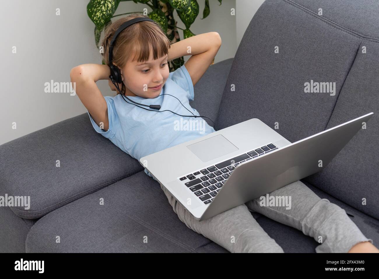 Child little girl with a laptop computer at home. Happy little child ...