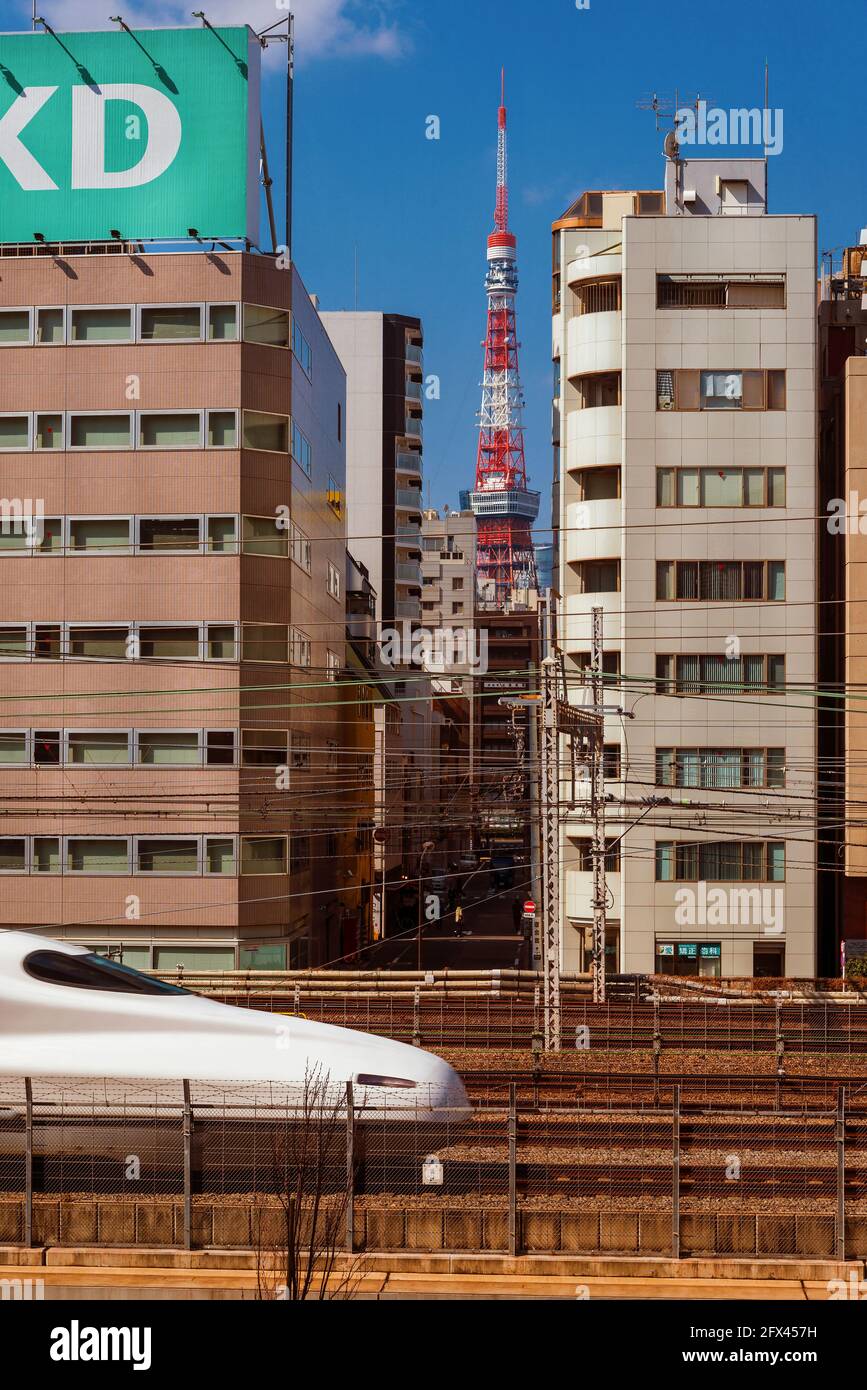 A Shinkansen, the famous japanese bullet train, passes through the city ...