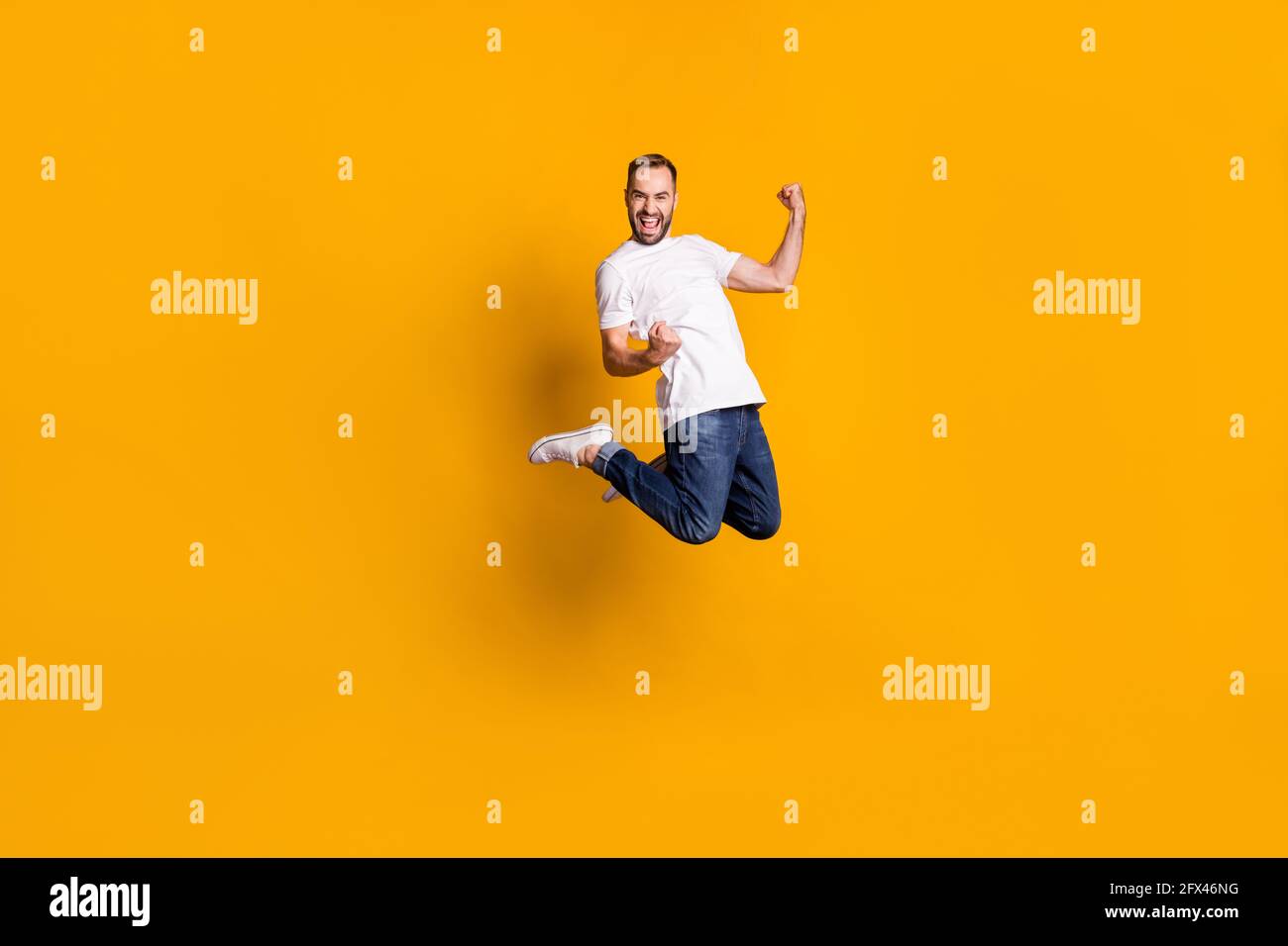 Full length body size view of nice lucky cheerful guy jumping rejoicing ...