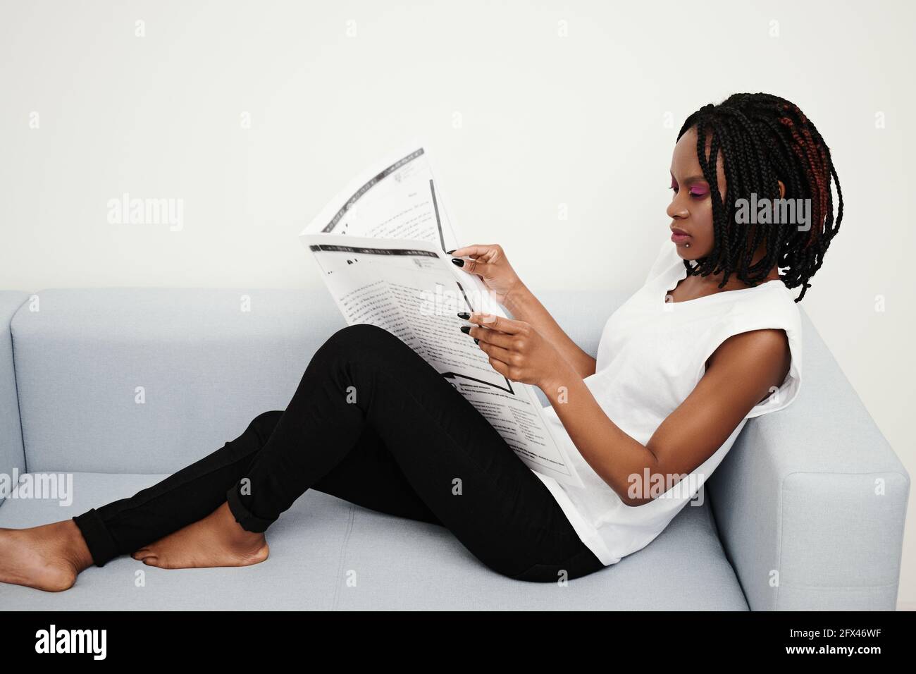 African american girl reading newspaper hi-res stock photography and ...