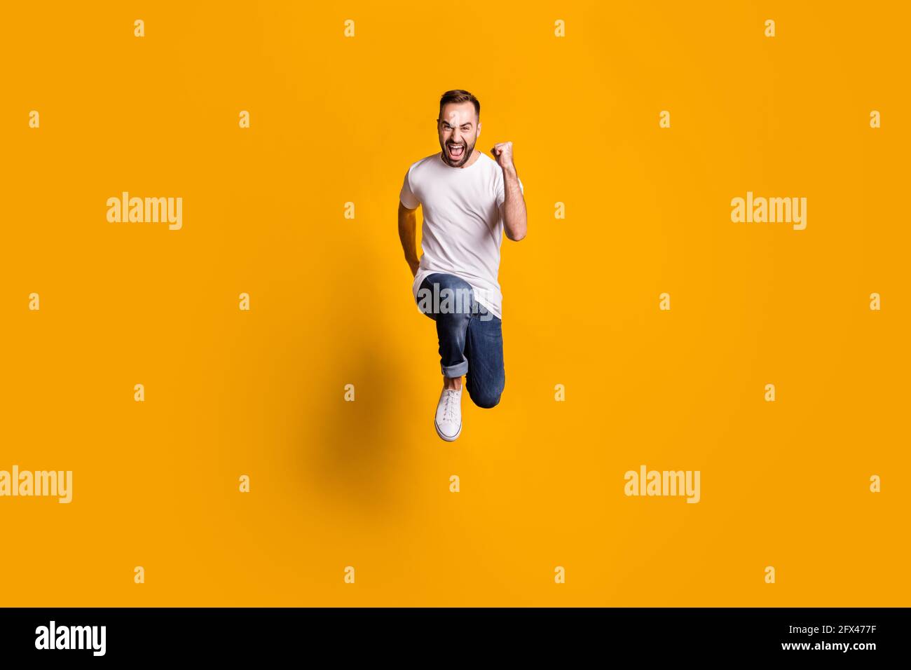 Full length body size photo of jumping cheerful male model running fast ...