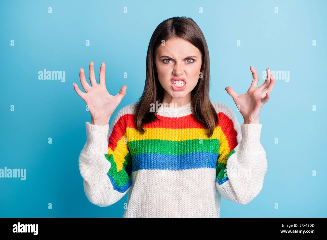 Photo of annoyed angry young woman dressed striped sweater showing ...