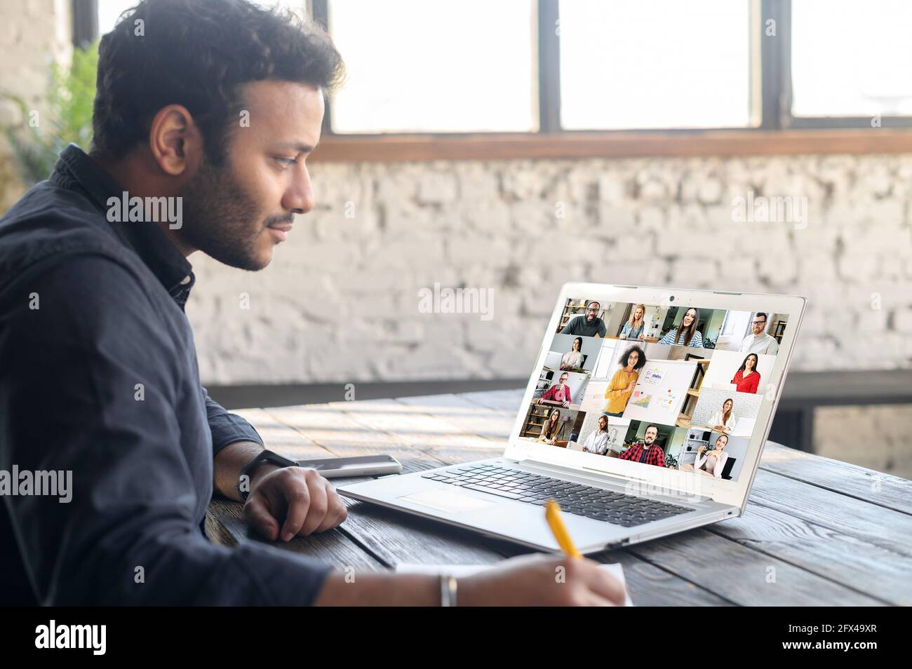 E-learning corporate training. Mixed-race indian man using laptop ...