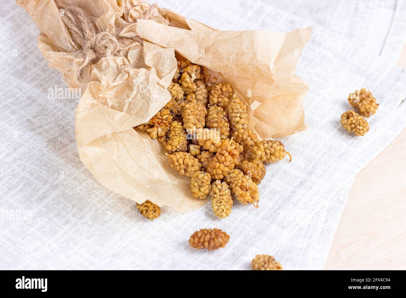 Dried sweet natural mulberry berries on light background in the kitchen ...