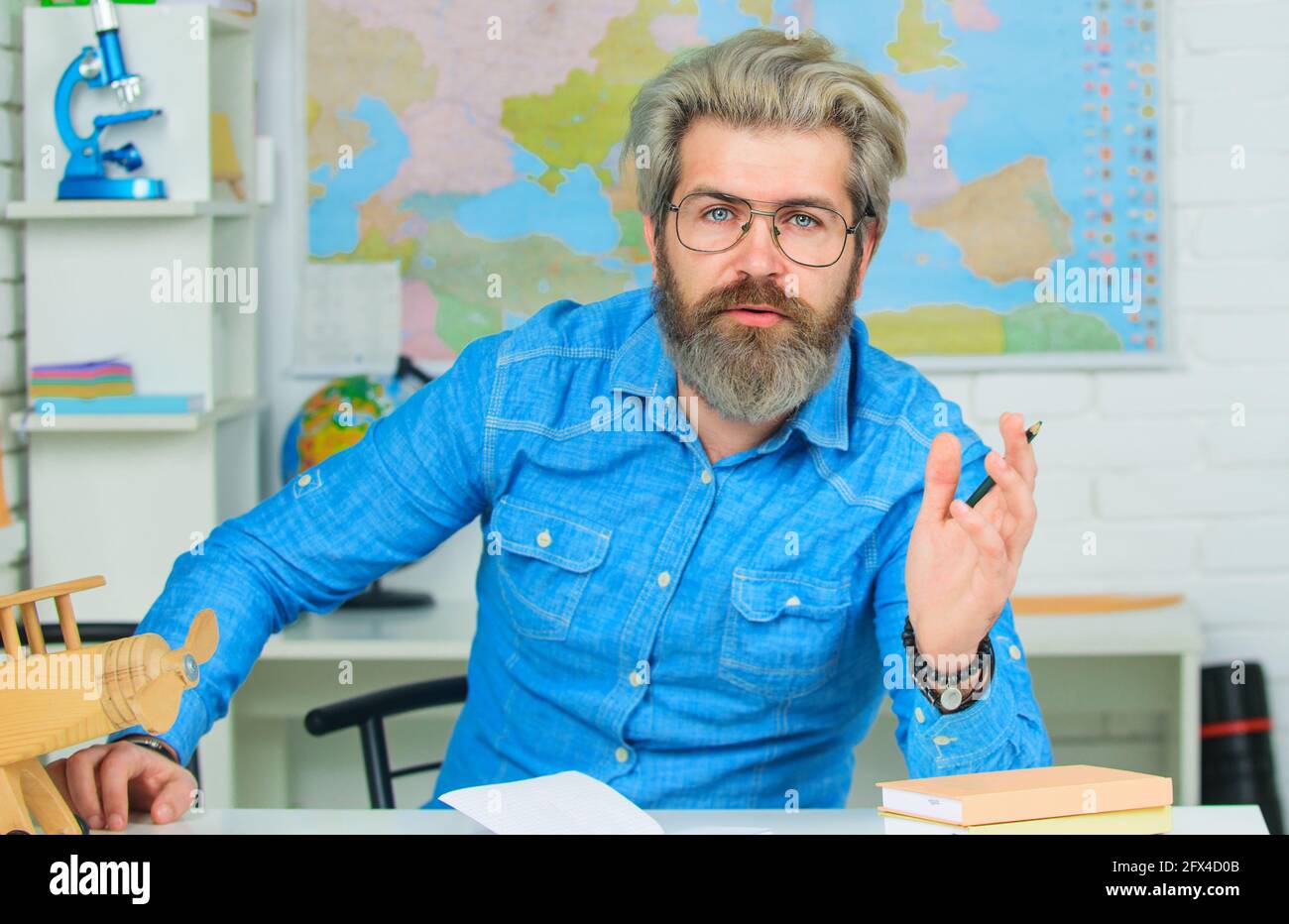 Learning, education, school concept. Serious teacher in classroom ...