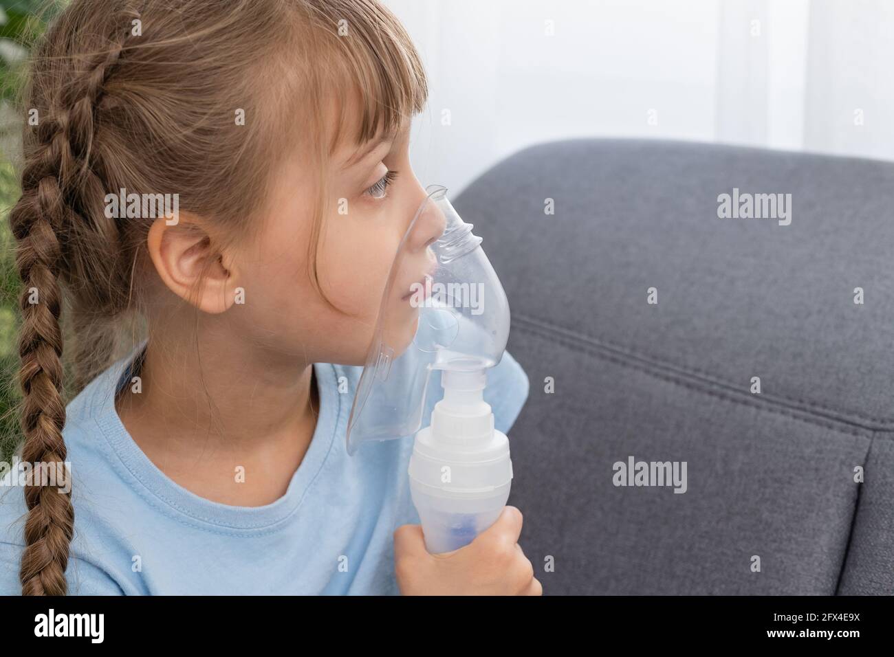 Little girl making inhalation with nebulizer at home. child asthma ...