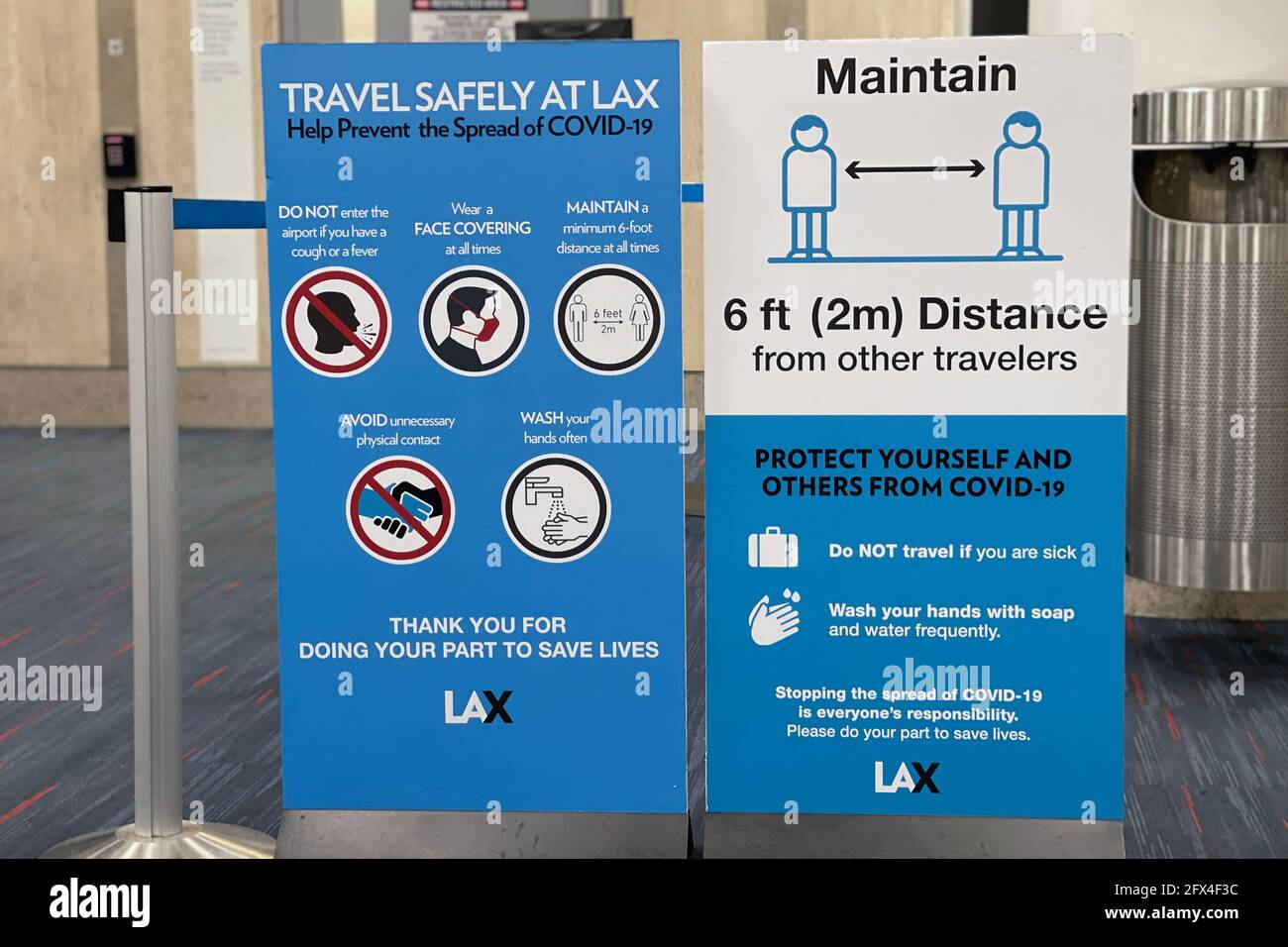 COVID-19 safety travel advisories signs at Gate 48B of Terminal 4 of ...