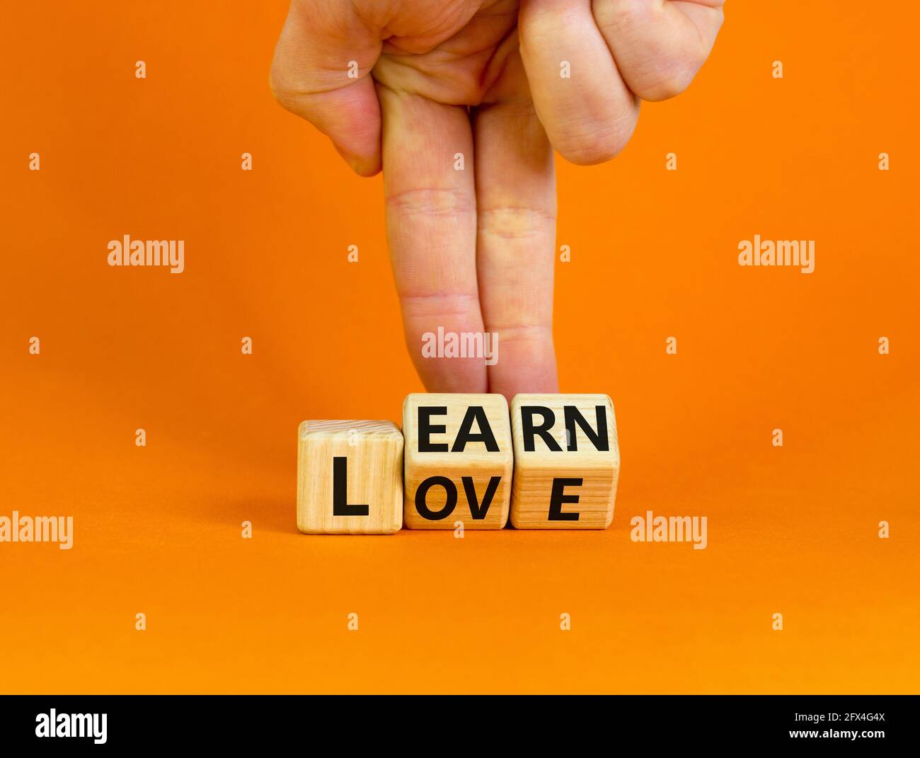 Learn to love symbol. Businessman turns wooden cubes and changes the ...