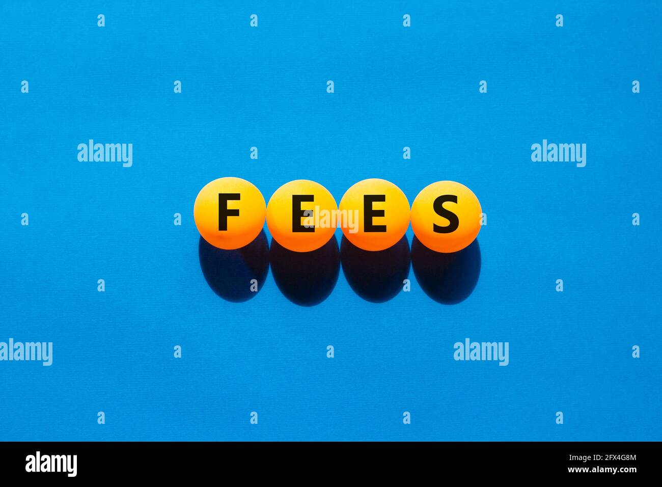 Business and fees symbol. Orange table tennis balls with the word 'fees ...