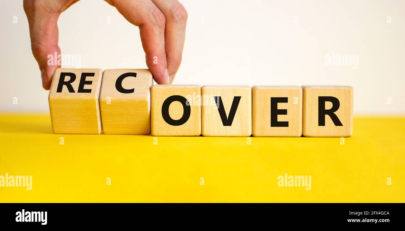 Time to recover symbol. Businessman turns wooden cubes and changes the ...