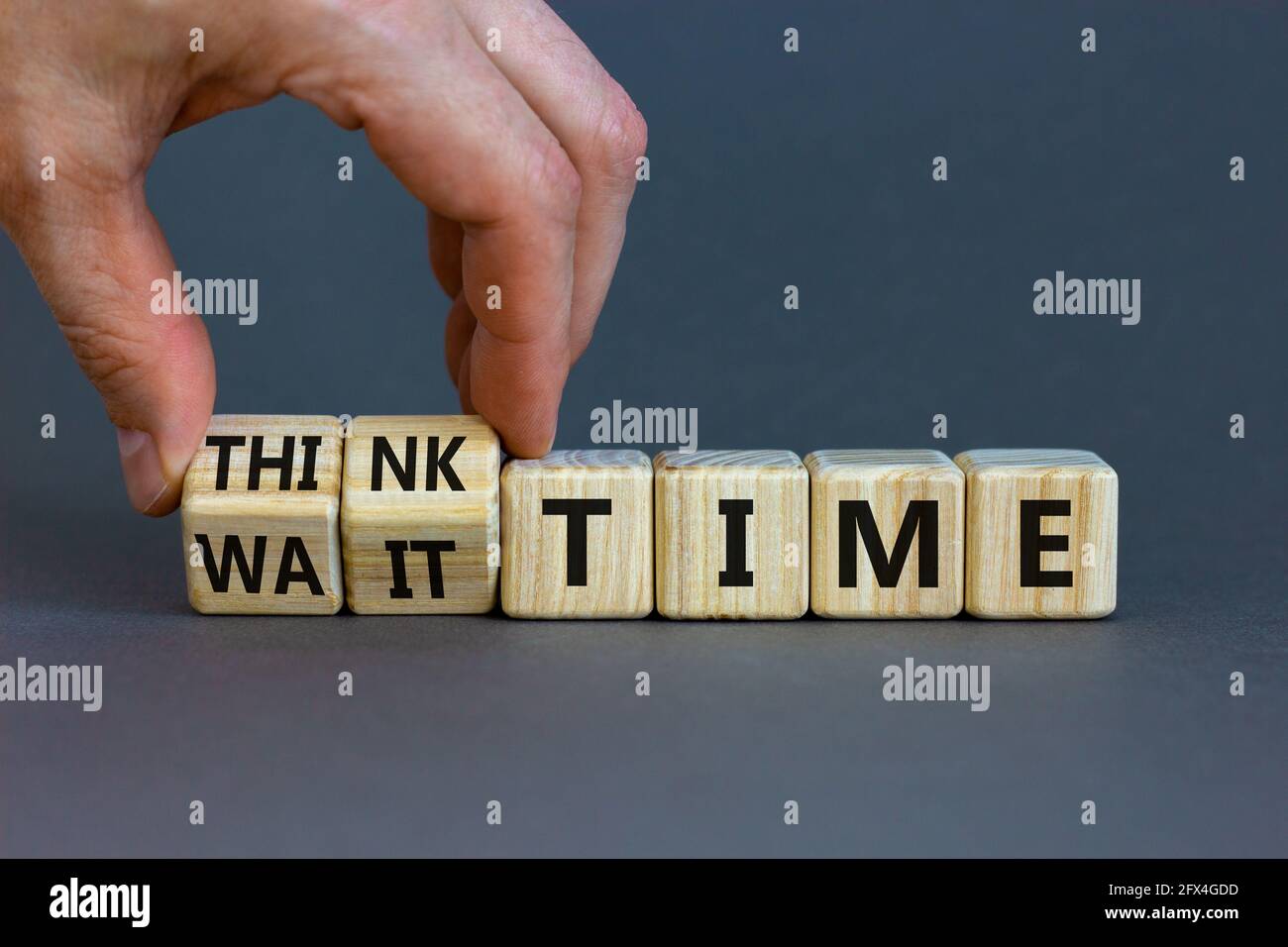 Think or wait time symbol. Businessman turns wooden cubes and changes ...