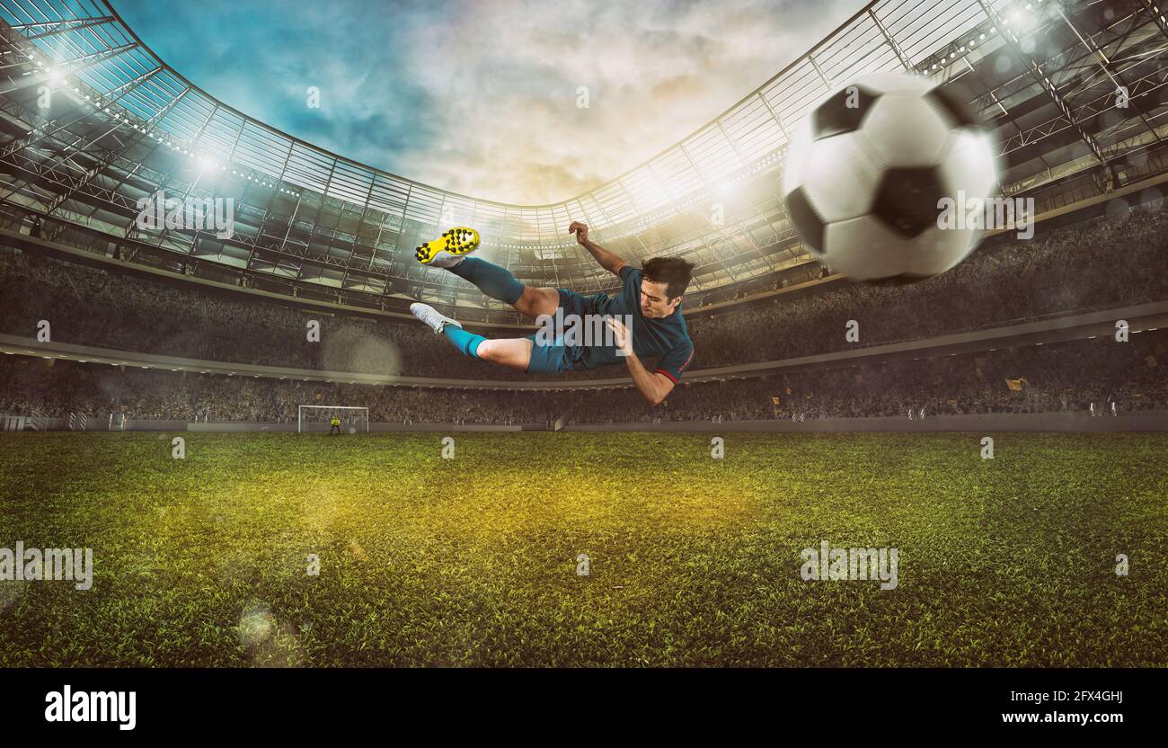 Soccer striker hits the ball with an acrobatic kick in the air at the ...