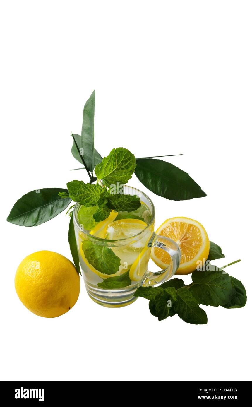 A glass glass of lemonade. Water with lemon slices, mint leaves and ice ...