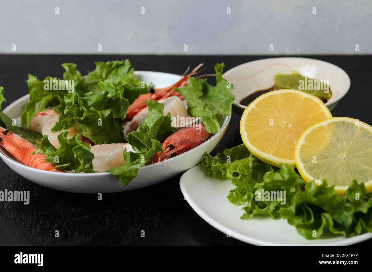 Natural raw scallop with boiled shrimp in the sink in a ceramic bowl ...