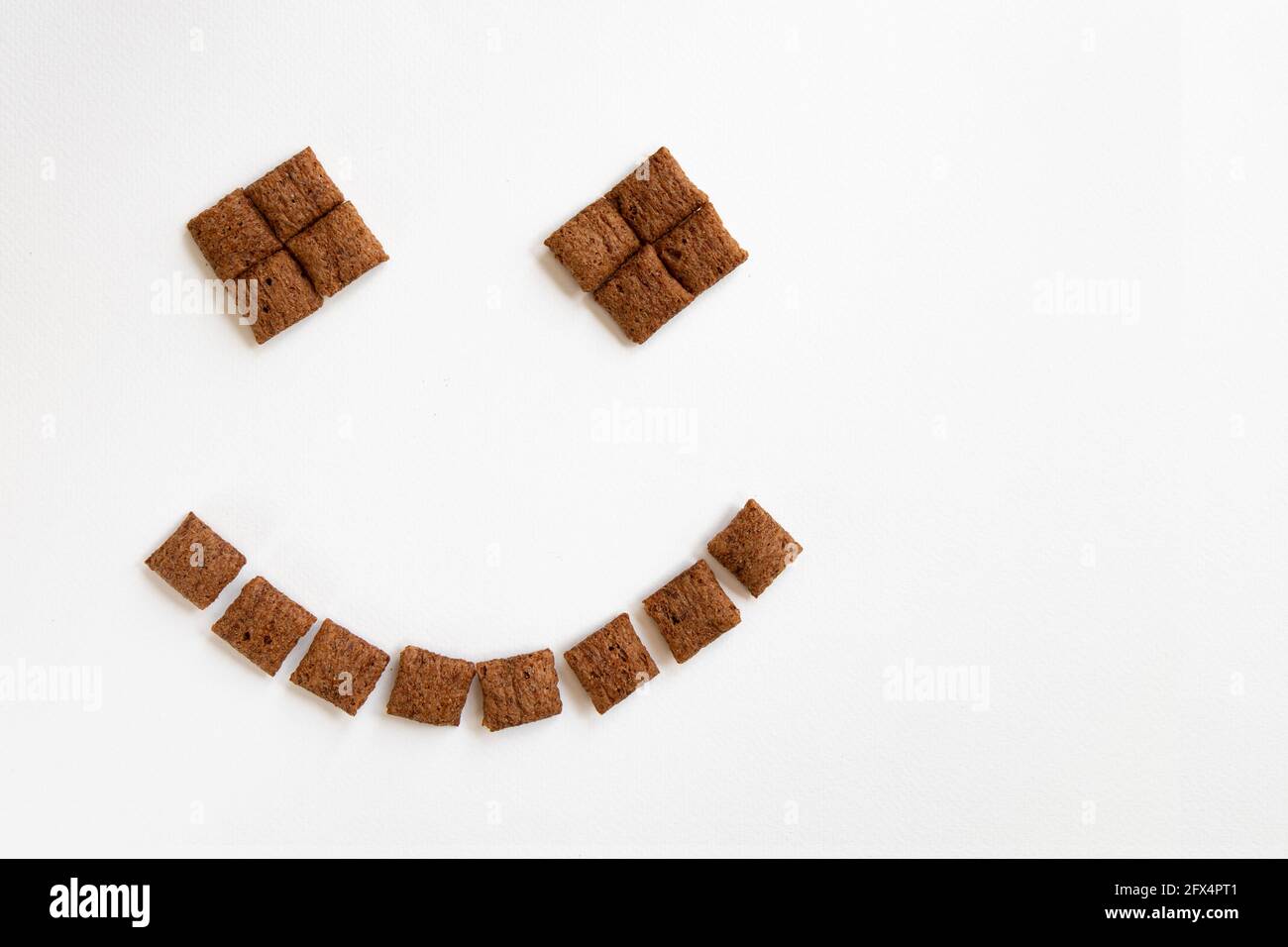 cereal muesli breakfast in the shape of smiling face on white ...