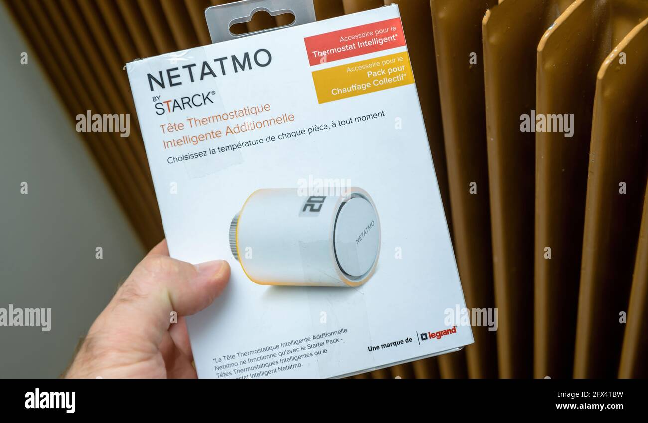POV male hand holding Netatmo by Stark intelligent radiator ...