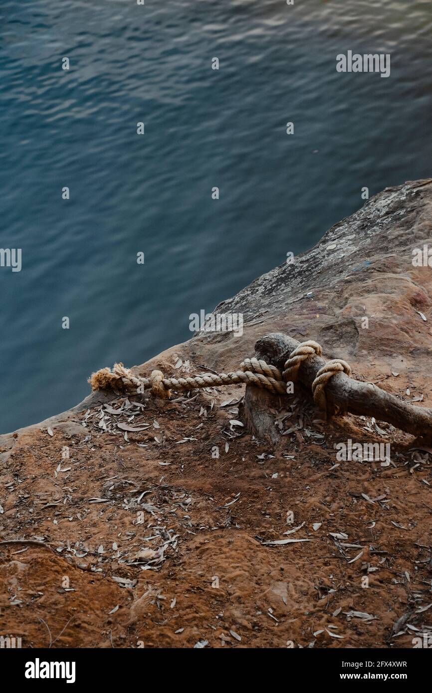 An old rope hanging off a rock at the water's edge at Berowra Waters ...