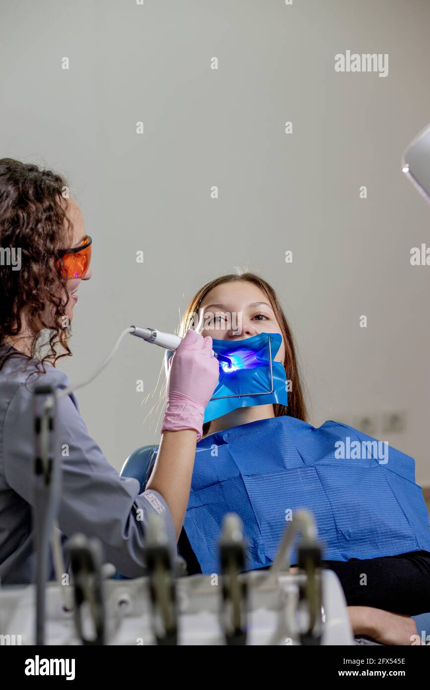 Laser bleaching teeth at dantist room. Teeth whitening for woman ...