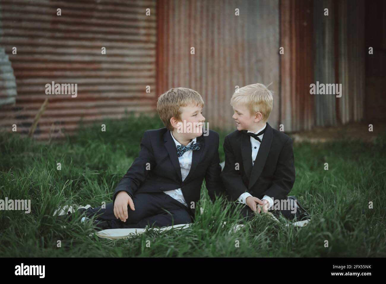 Adorable Australian boys wearing black suits laughing and looking at ...