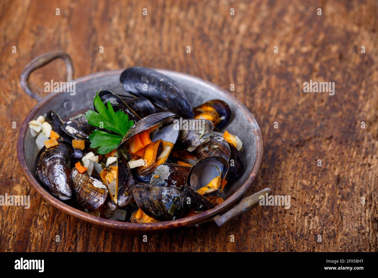 cooked mussels on dark wood Stock Photo - Alamy
