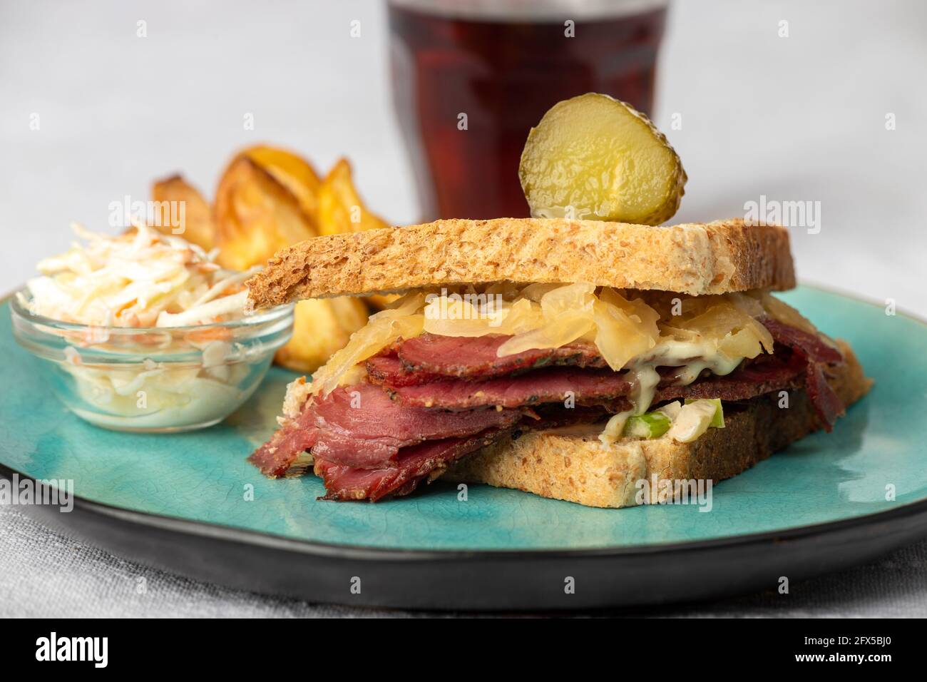 reuben sandwich on a plate with fries Stock Photo - Alamy