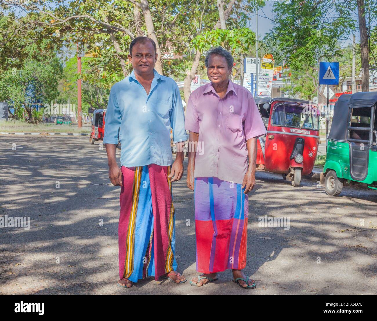 Sri Lankan auto-rickshaw drivers stand posing for portrait, Kataragama ...