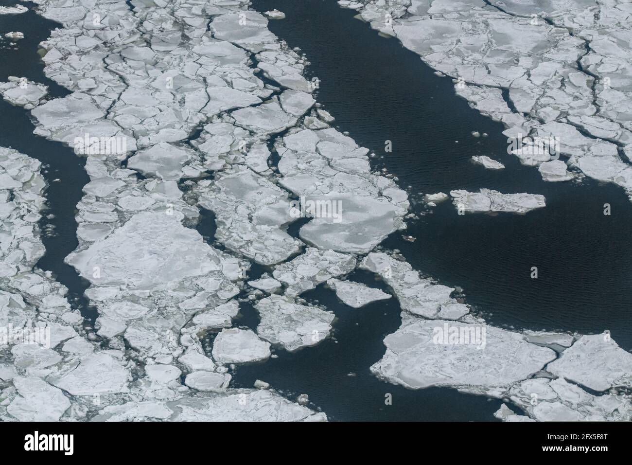 Stunning abstract view of sea ice that is partially frozen from above ...